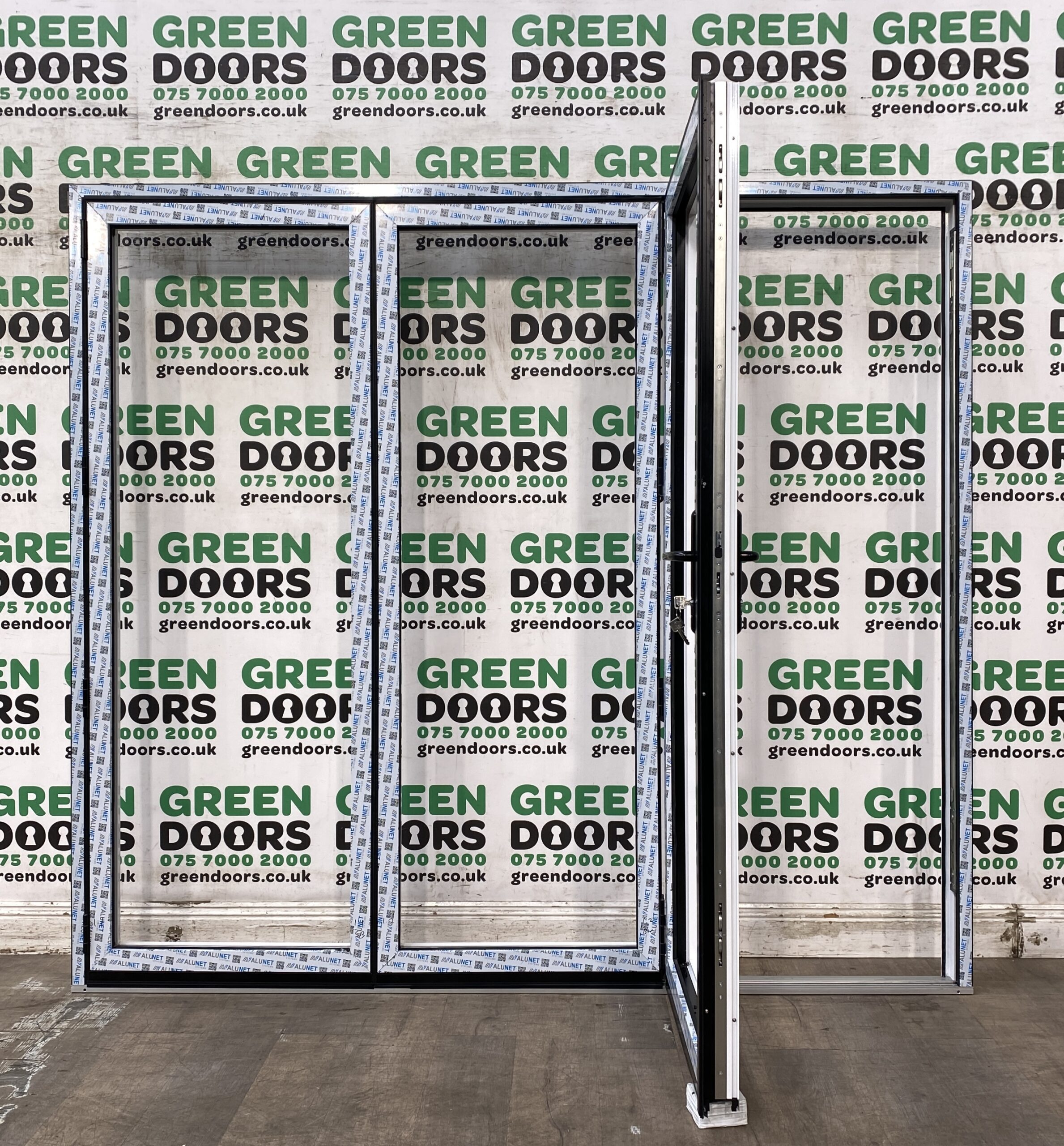 Black Aluminium Bi-folding doors | Green doors